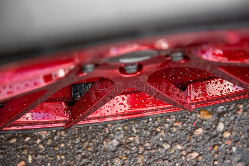 Red Candy Colored Light Alloy Wheels on Asphalt Background. in ...