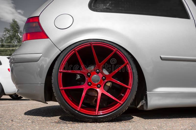 Red Candy Colored Light Alloy Wheels on Silver Hatchback Stock Photo ...