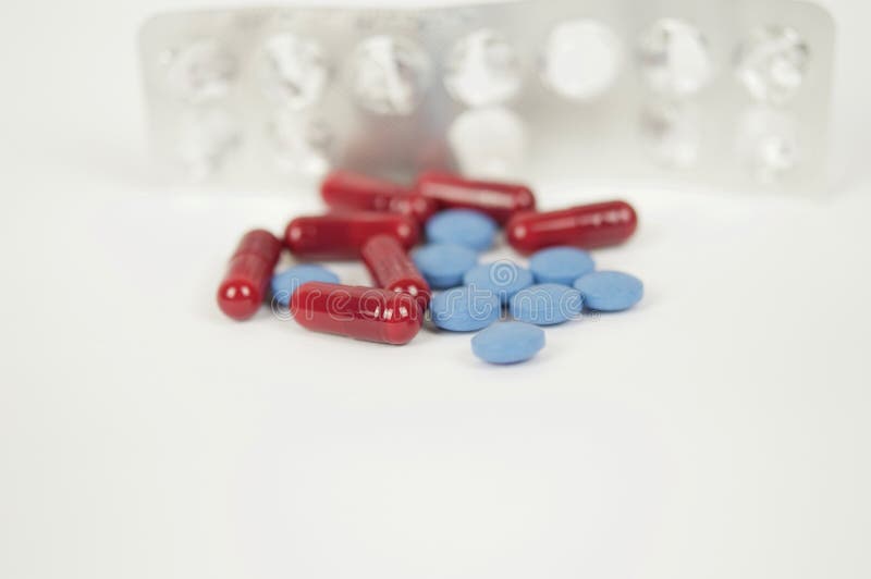 Red Capsules and Blue Tablets Isolated Stock Image - Image of medical ...