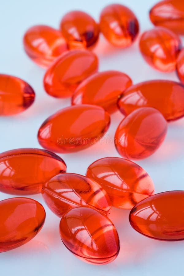 Red Capsules on a White Surface Stock Photo - Image of healthcare ...