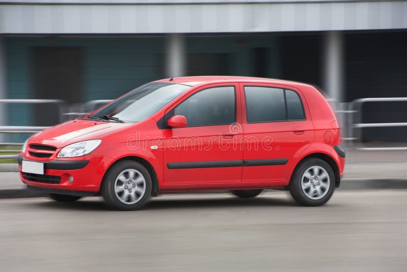 Red Car Goes on City Street Stock Image - Image of street, side: 24705397