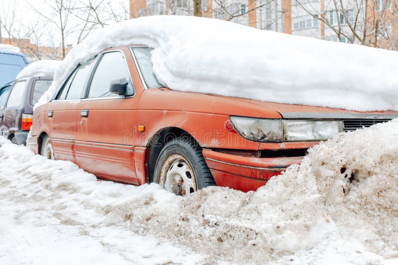 Red Car Parked in Snowdrift. Old Rusty Auto Covered in Snow. Wheel ...
