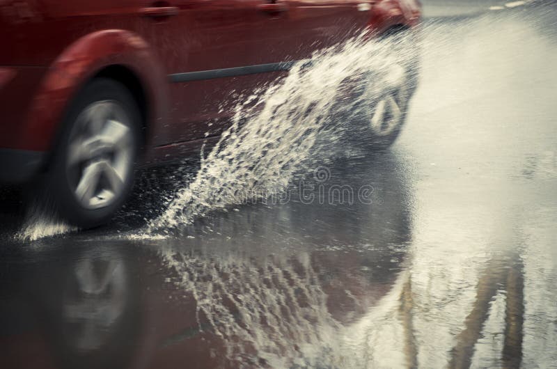 Red Car Rides on Big Puddle. Water Splash. Stock Photo - Image of ...