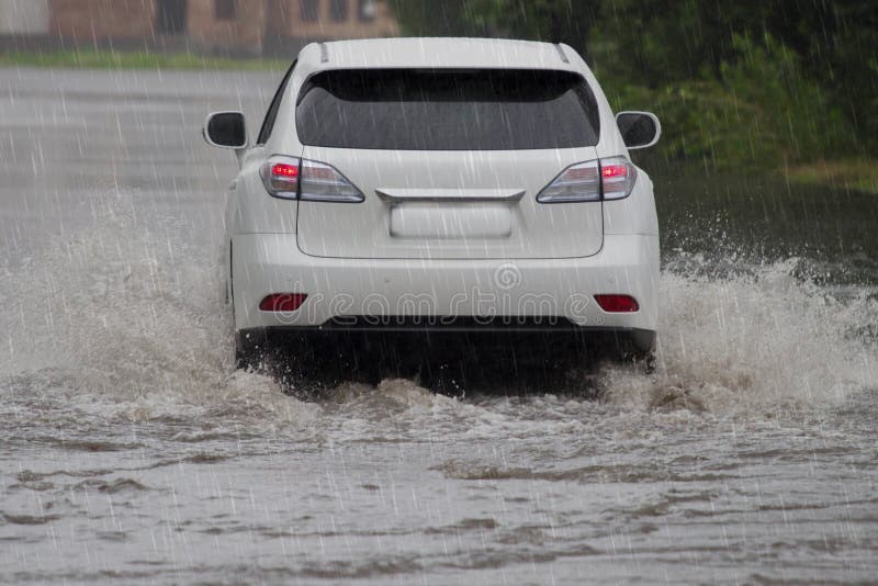 Red Car Rides in Heavy Rain on a Flooded Road Stock Image - Image of ...