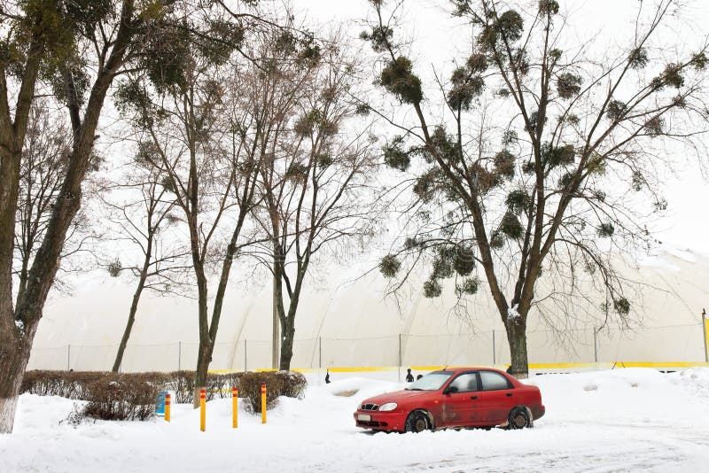 Red Car in the Snow Near the Indoor Playground Stock Photo - Image of ...