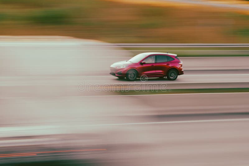 Red Car Speeding in Motion on a Highway on a Sunny Day Stock Photo ...