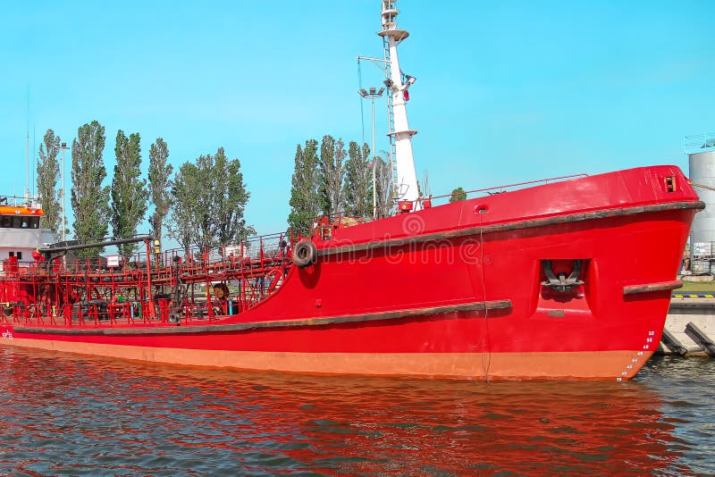 Red Cargo Ship Docked at Seaport for Loading Operations. Ship with Red ...
