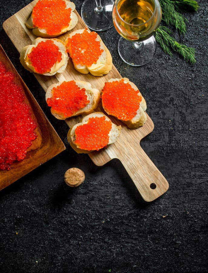 Red Caviar on Bread Slices and Red Caviar on a Plate with the Wine ...