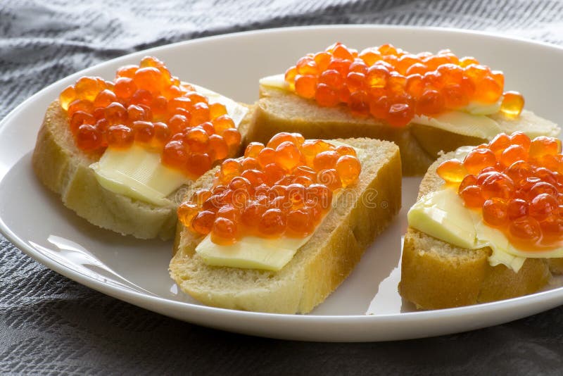 Red Caviar with Butter and Baked Bread. Close-up Stock Photo - Image of ...