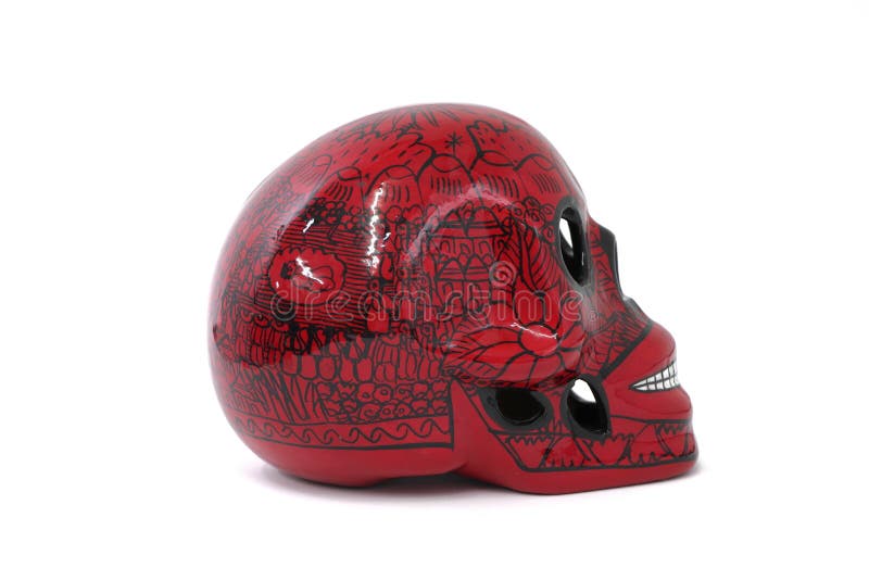 Red Ceramic Skull with Black Side Details on a White Background Stock ...