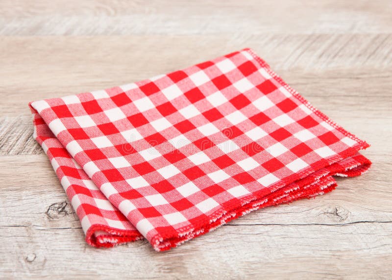 Red Checkered Tablecloth Folded in Two on a Wooden Table Stock Photo ...