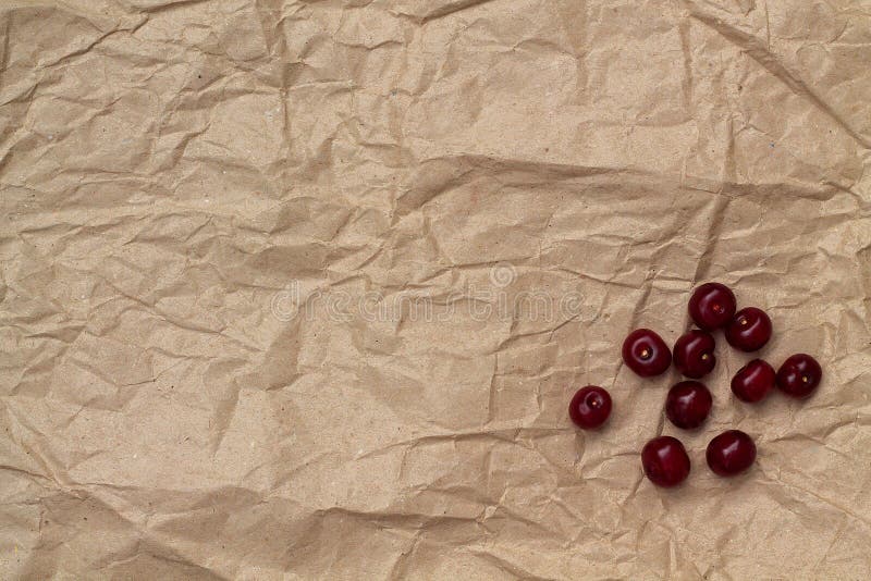Red Cherry Lies on Crumpled Brown Paper Stock Image - Image of texture ...