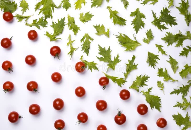 Red Cherry Tomatoes and Green Rucola Salad Leaves on White Background ...