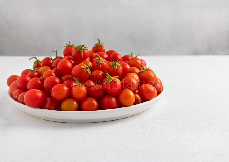 Red Cherry Tomatoes in a White Dish on a Light, Minimalism Stock Image ...
