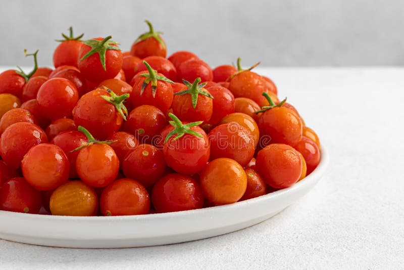 Red Cherry Tomatoes in a White Dish on a Light, Minimalism Stock Photo ...