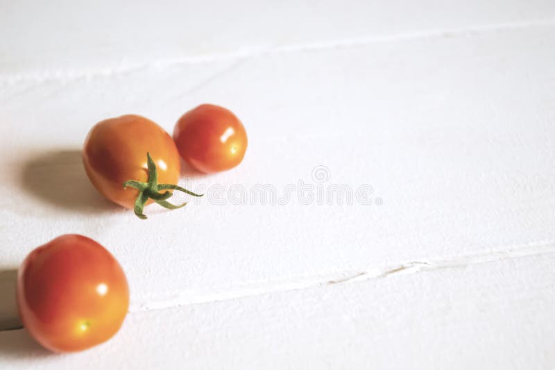 Red Cherry Tomatoes on a White Table. Cherry Tomato - a Few Pieces are ...