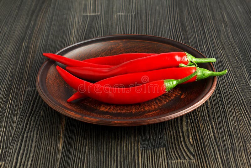 Red Chili Pepper in a Clay Plate Stock Photo - Image of food, spice ...