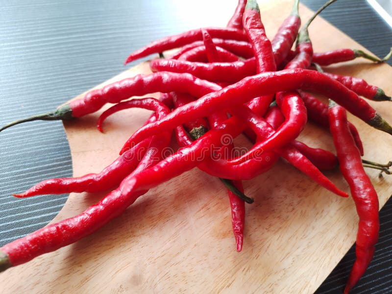 Red Chili Peppers on a Brown Cutting Wooden Board Collection Photo ...