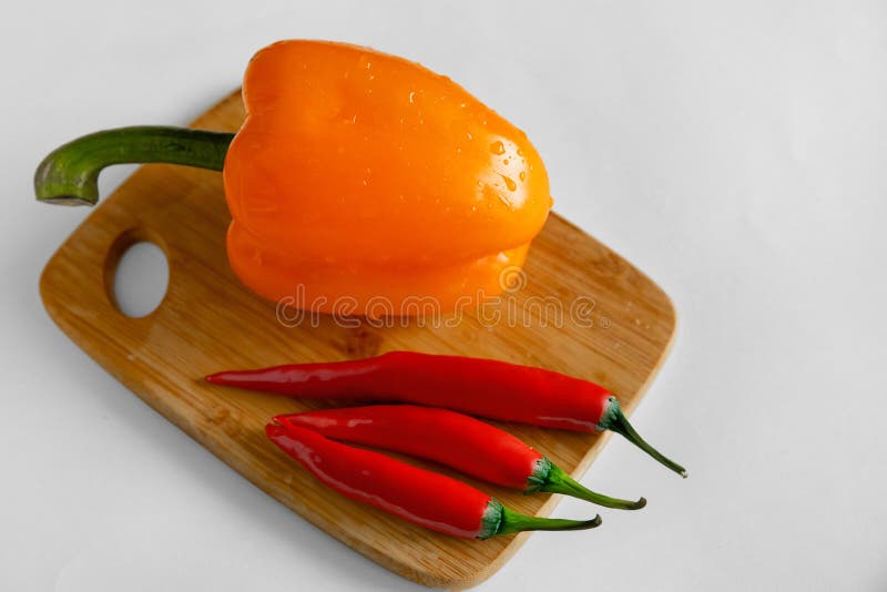 Red Chilli and Orange Sweet Pepper on White Background Stock Image ...