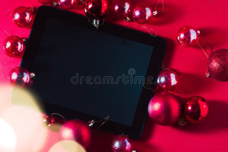Red Christmas Balls with Black Tablet on a Red Stock Image - Image of ...