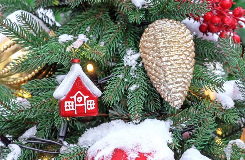 Red Christmas Small Hut and Golden Pine Cone on the Christmas Tree ...