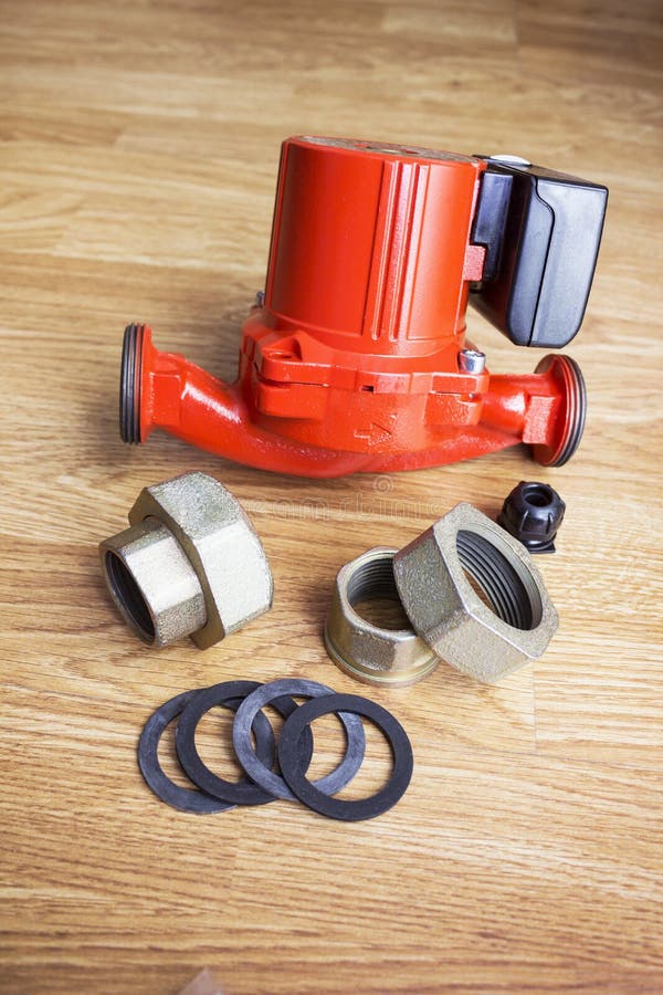 Red Circulation Pump for Heating System and Fasteners for it Lies on ...