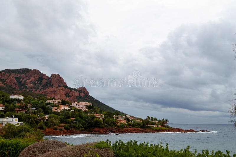 Red cliffs, France stock photo. Image of house, clouds - 102137794
