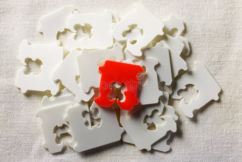 A Red Clip with a Collection of Flat White Plastic Bread-bag Clips ...