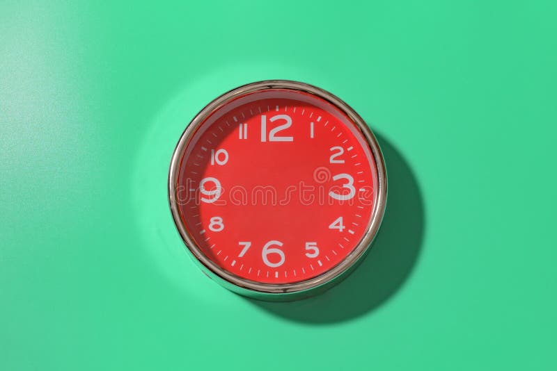 Red Clock without Hands with Large White Numbers on a Green Background ...