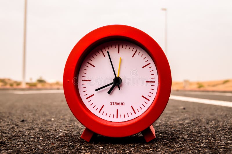 A Red Clock with the Hands at the Numbers 3 and 5 Stock Image - Image ...