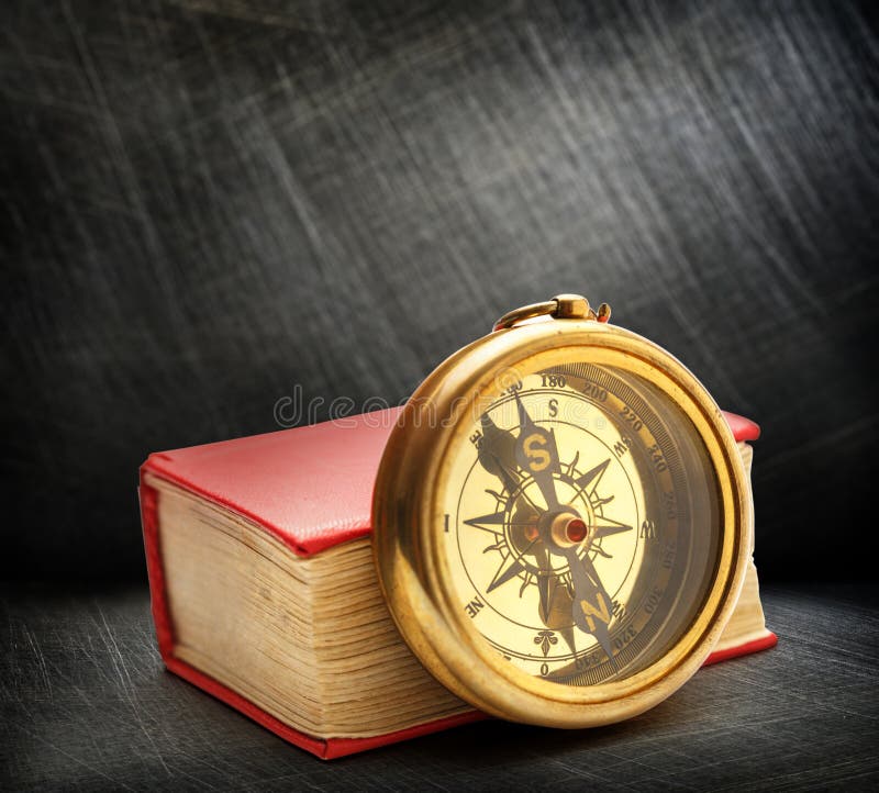 Compass and a book stock photo. Image of direction, plan - 22451448