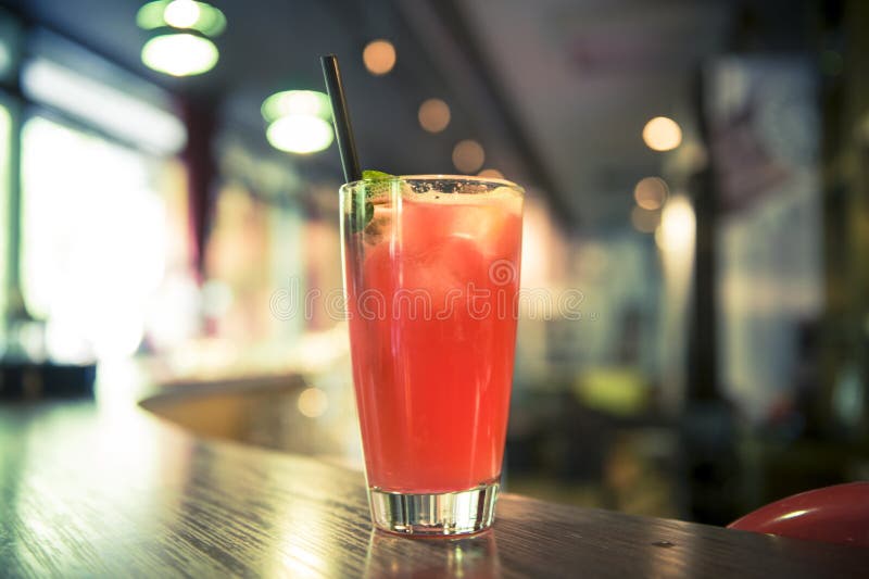 Red cocktail on the bar stock photo. Image of juice, garnish - 78551506