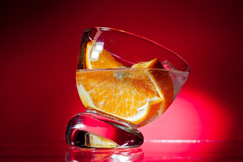 Red Cocktail Isolated On A Red Strip With A Slice Of Orange Background For Alcoholic And Non