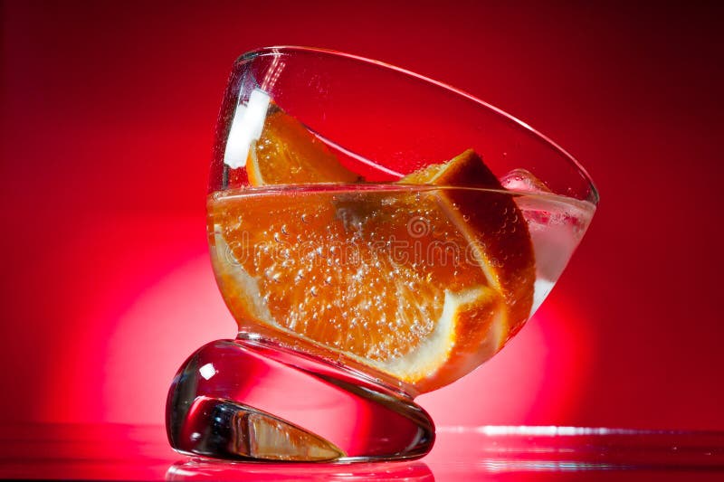 Red Cocktail Isolated On A Red Strip With A Slice Of Orange Background For Alcoholic And Non