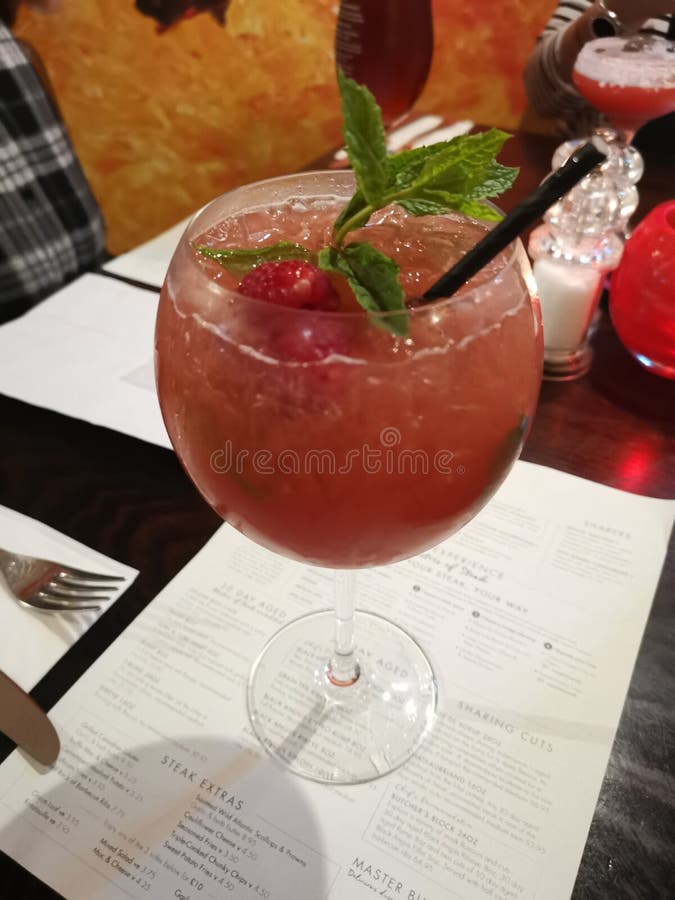 Cocktail with Raspberry Topping and Sunset Background for Vibrant Drink ...