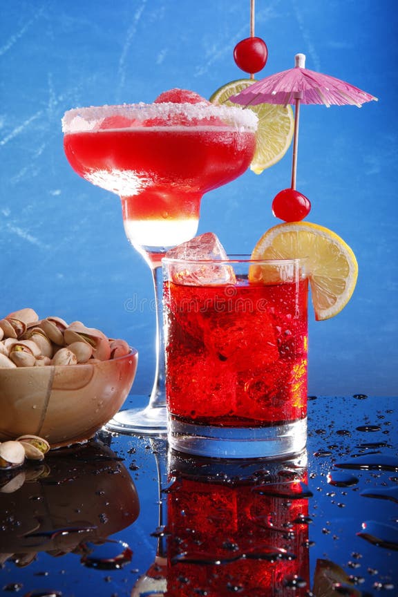 Red cocktails on blue stock image. Image of garnished - 10091119