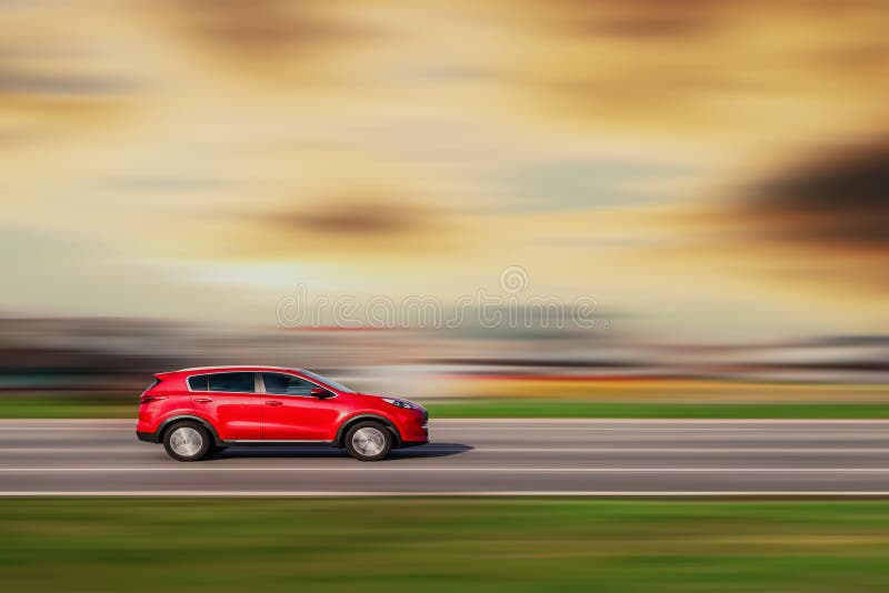 Red Color Car Driving at High Speed with Blurred Background Stock Photo ...