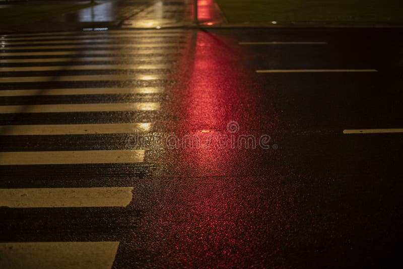The Red Color of the Traffic Light is Reflected on the Pedestrian ...