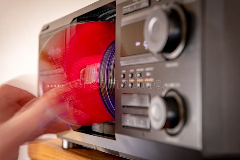 A Red Colored CD is Placed into Its Player Stock Photo - Image of play ...