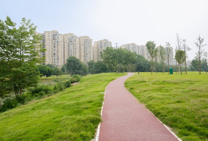 Red-colored Path in Lawn To Multi-storied Apartments Stock Image ...