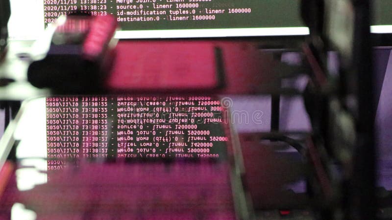 Red Computer Software Code Moving on a Black Monitor Reflect on Glass. Abstract Computer Hacking ...