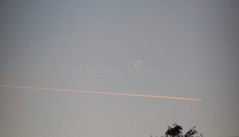 Red Condensation Stripe of a Airplane on Sky Stock Photo - Image of ...