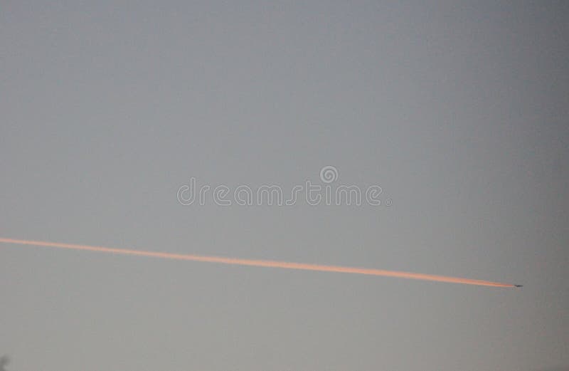 Red Condensation Stripe of a Airplane on Sky Stock Photo - Image of ...