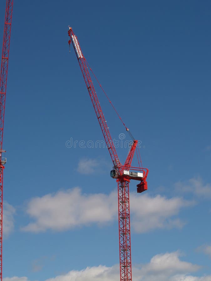Red Construction Cranes with Blue Sky White Clouds Stock Image - Image ...