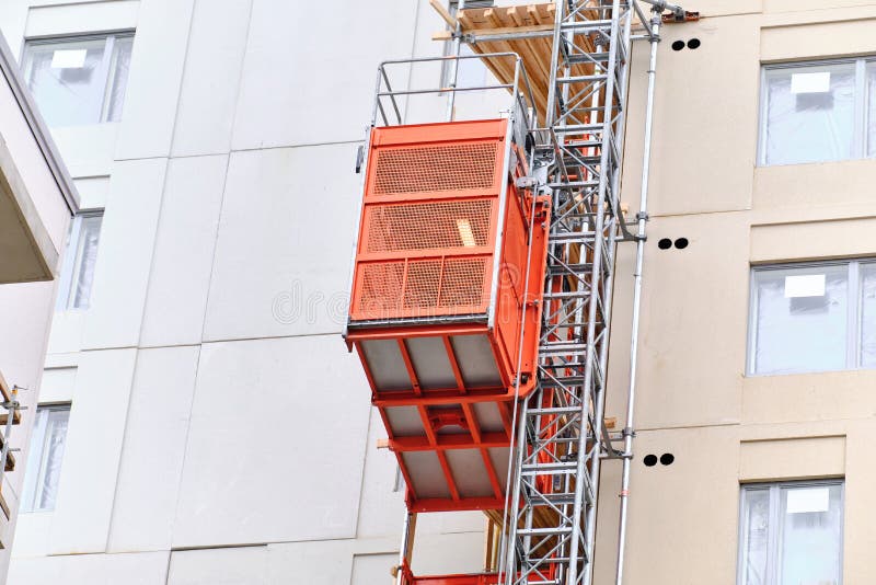 The Red Construction Elevator on the Facade of the Building Stock Image ...