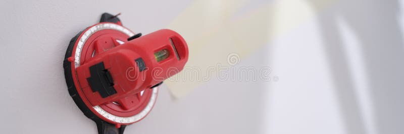 Red Construction Laser Level Fixed on White Wall Stock Photo - Image of ...