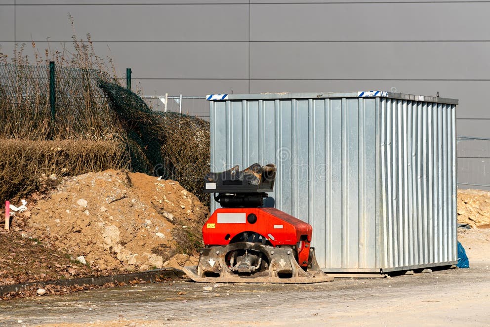 Red Construction Machine for Soil Compaction on Site Next To Container ...