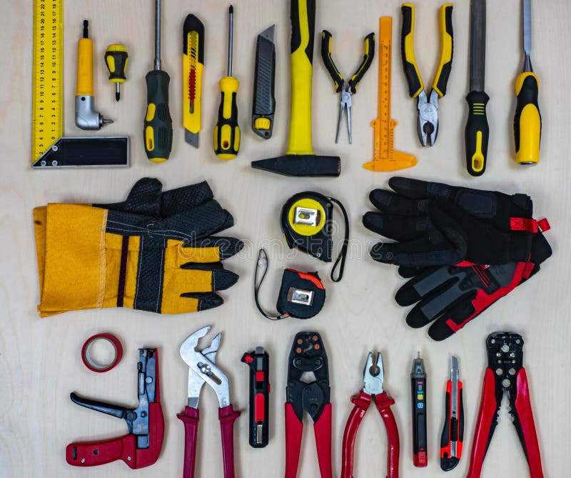 A Red Construction Tools Vs a Yellow Working Tools on a Plywood ...