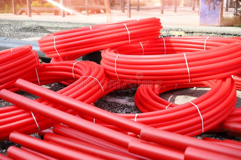 Red Corrugated Pipe for Wire at Construction Site. Cable Conduit for ...