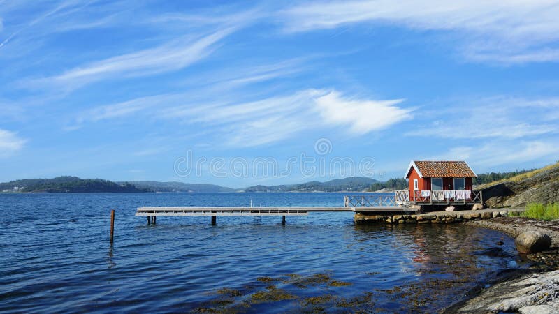A Red Cottage and Dock by the Sea Stock Image - Image of landscape ...